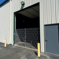 Double Folding Scissor Gates for Warehouse Roll Up Doors - Warehouse ...